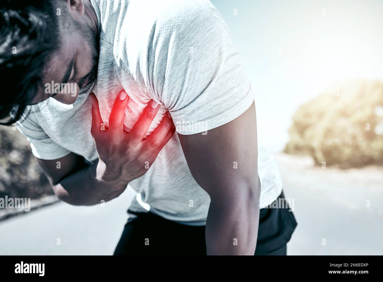Closeup fit mixed race man holding his chest in pain while exercising ...