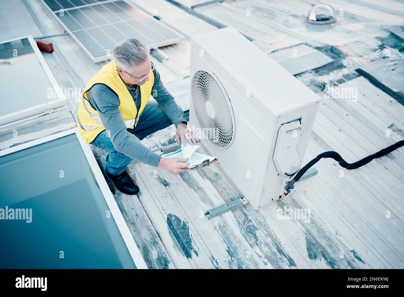 Air conditioning, roof and engineering man for maintenance, inspection and solar panel in ...