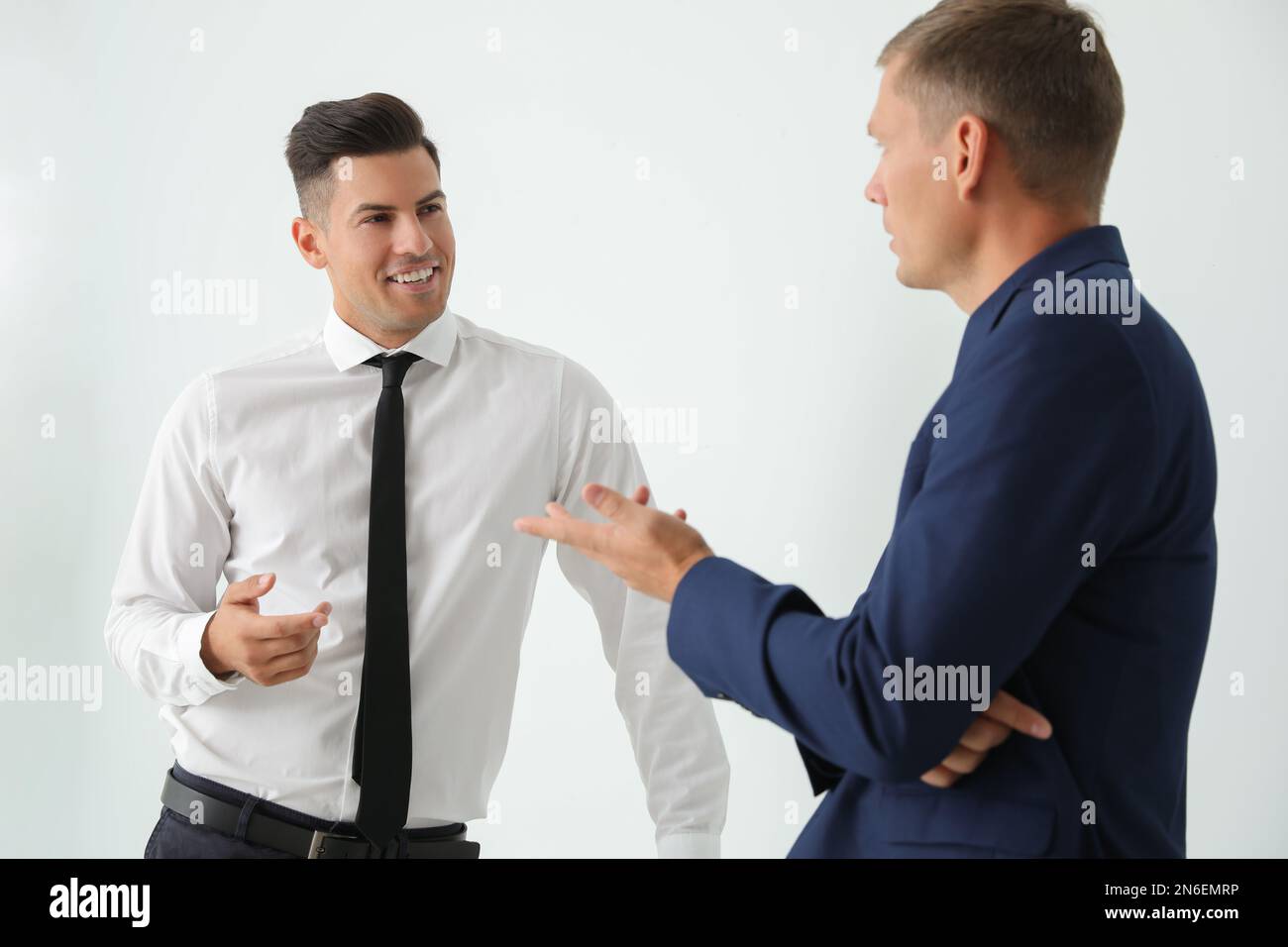 Office employees talking at workplace during break Stock Photo - Alamy