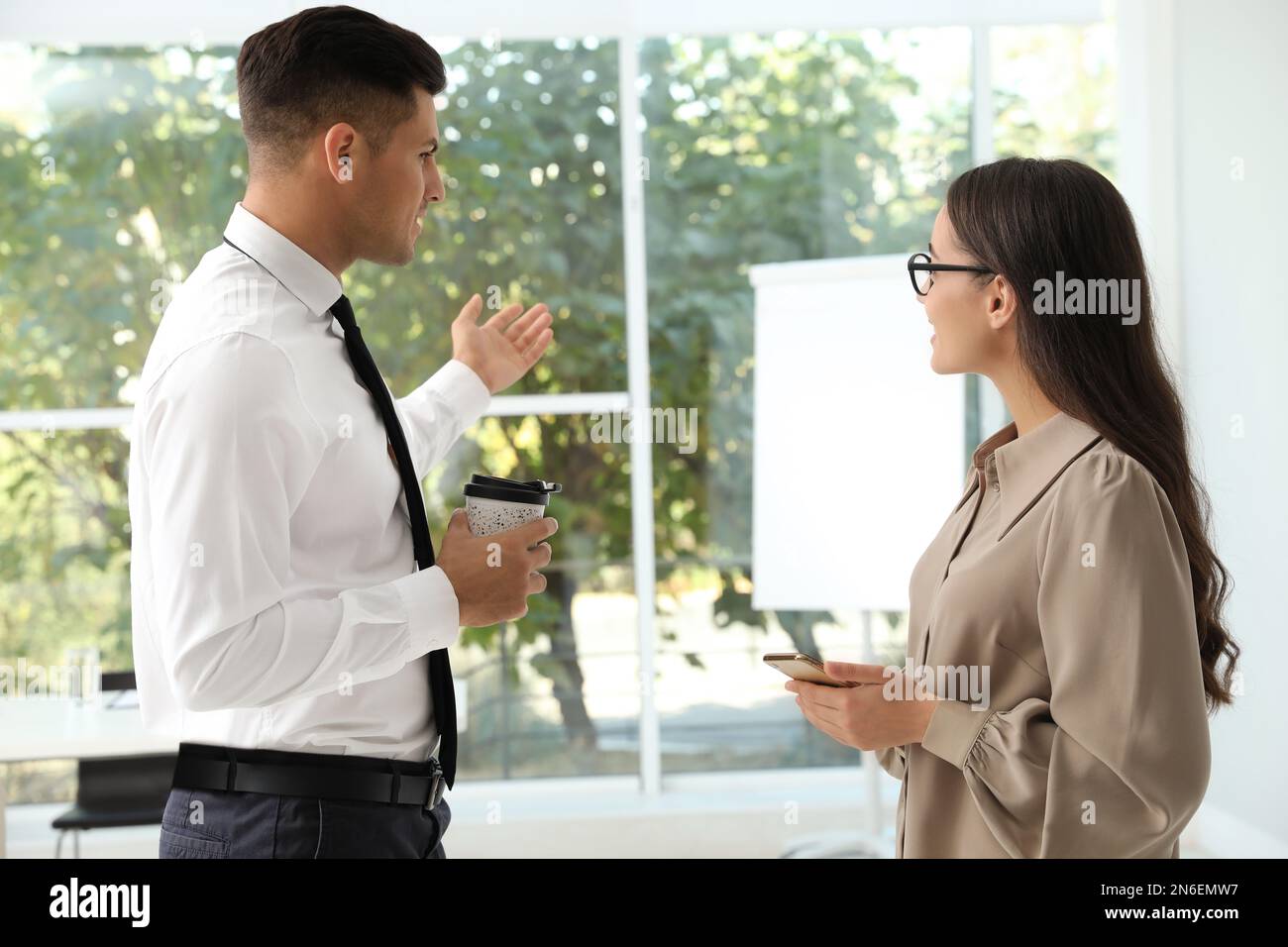 Office employees talking at workplace during break Stock Photo - Alamy