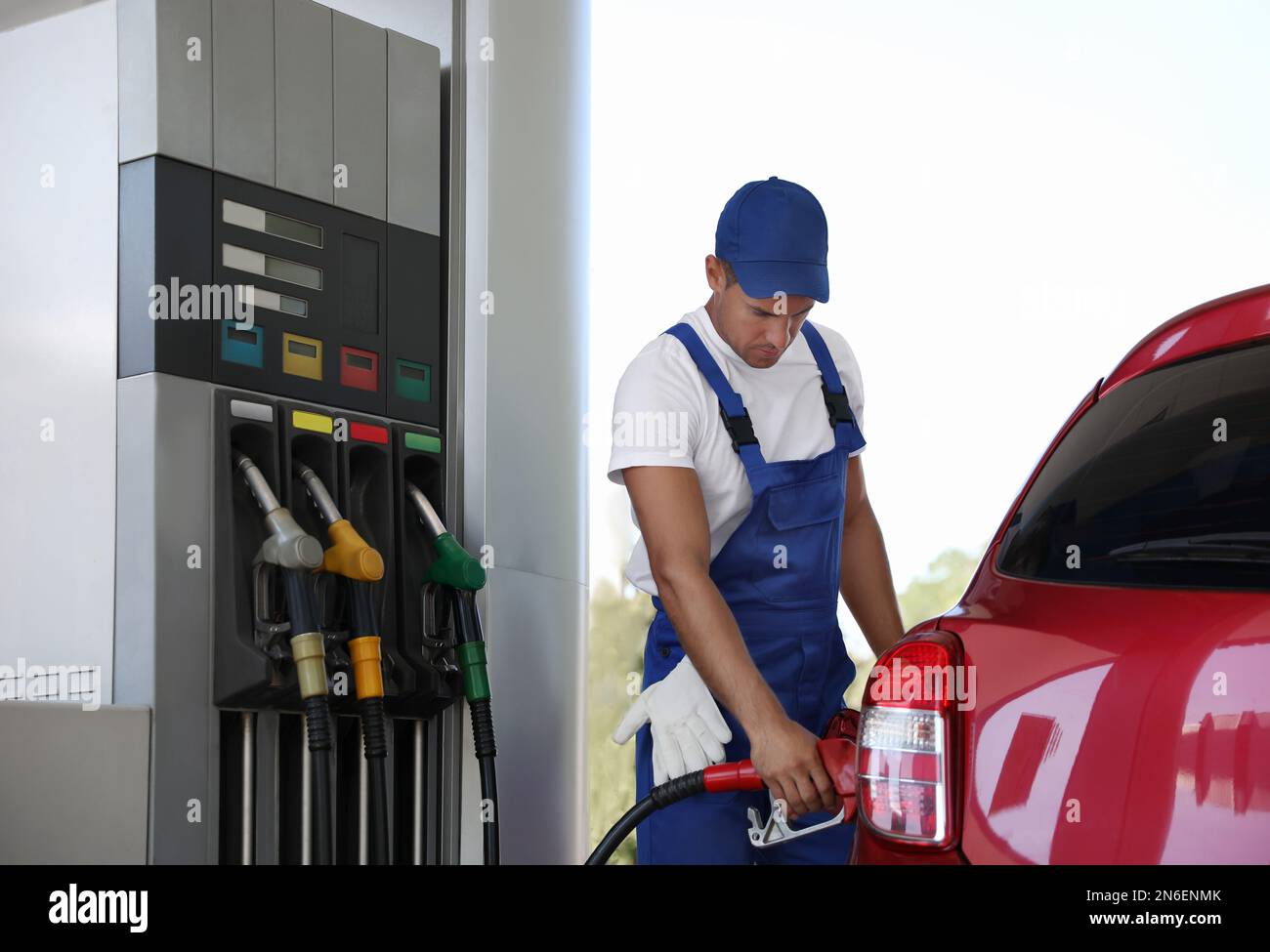 Worker refueling car at modern gas station Stock Photo - Alamy