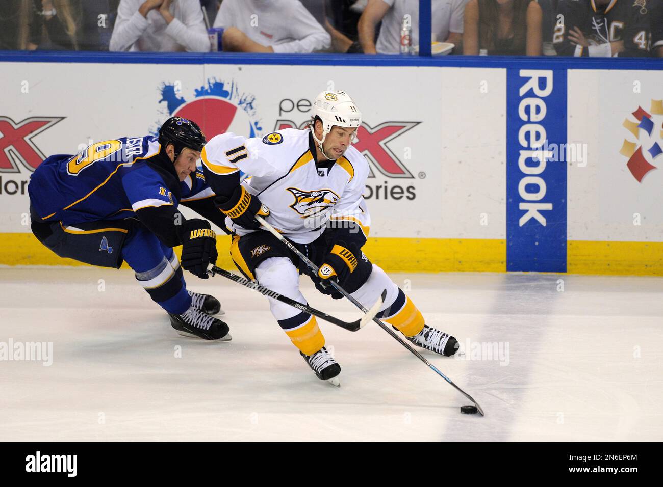 St. Louis Blues' Jay Bouwmeester, left, reaches in front of Nashville ...