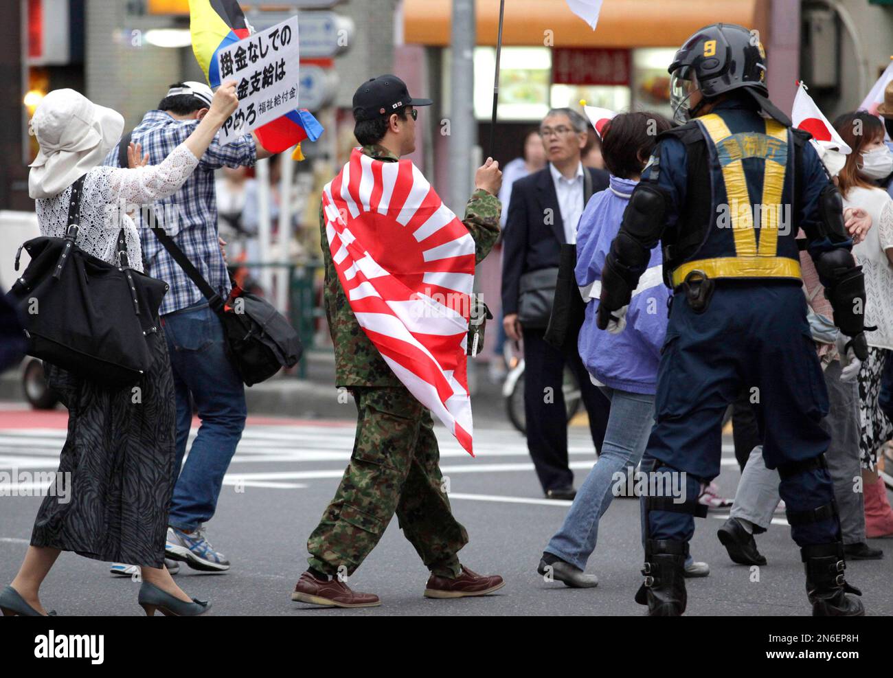 In this photo taken Sunday, May 19, 2013, nationalist protesters march ...