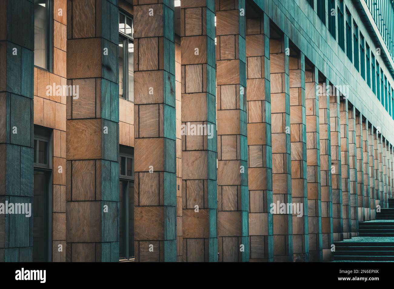 Side view of the facade of a modern building with columns in the golden ...