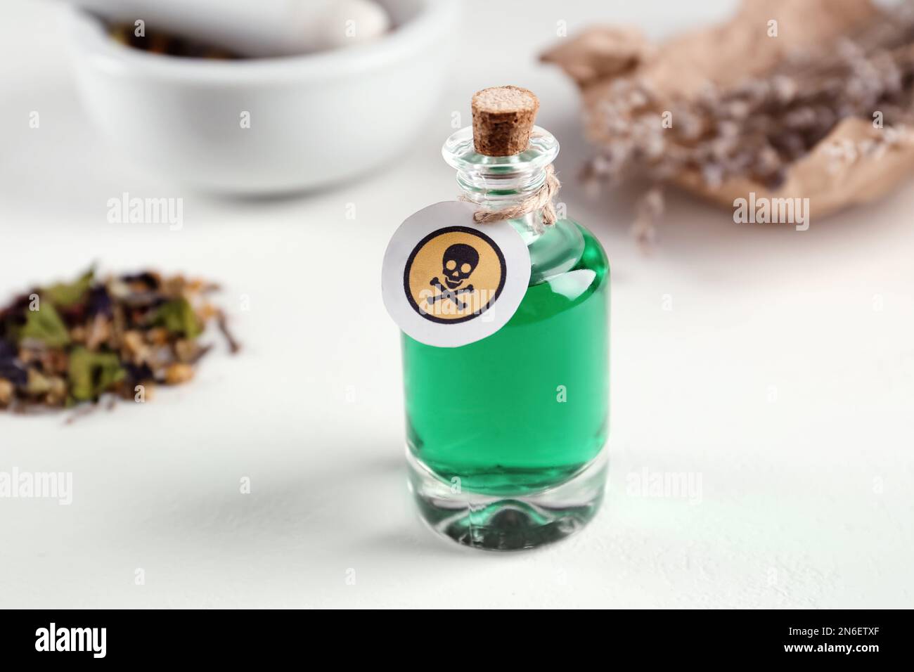 Glass bottle of poison with warning sign on light background Stock ...