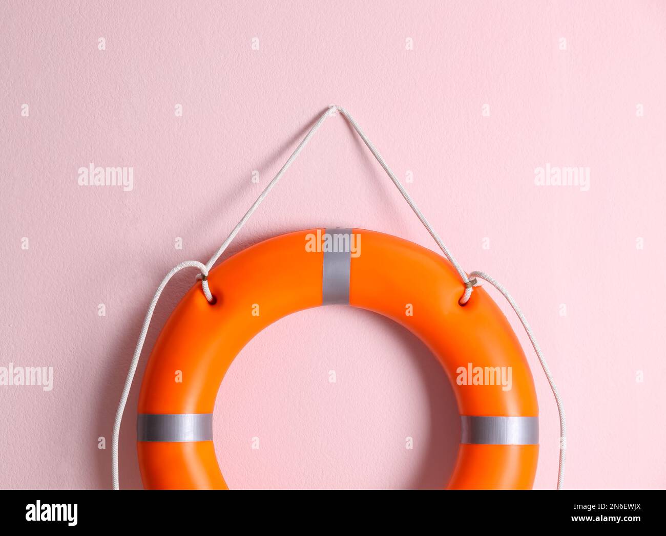 Orange lifebuoy on pink background. Rescue equipment Stock Photo - Alamy