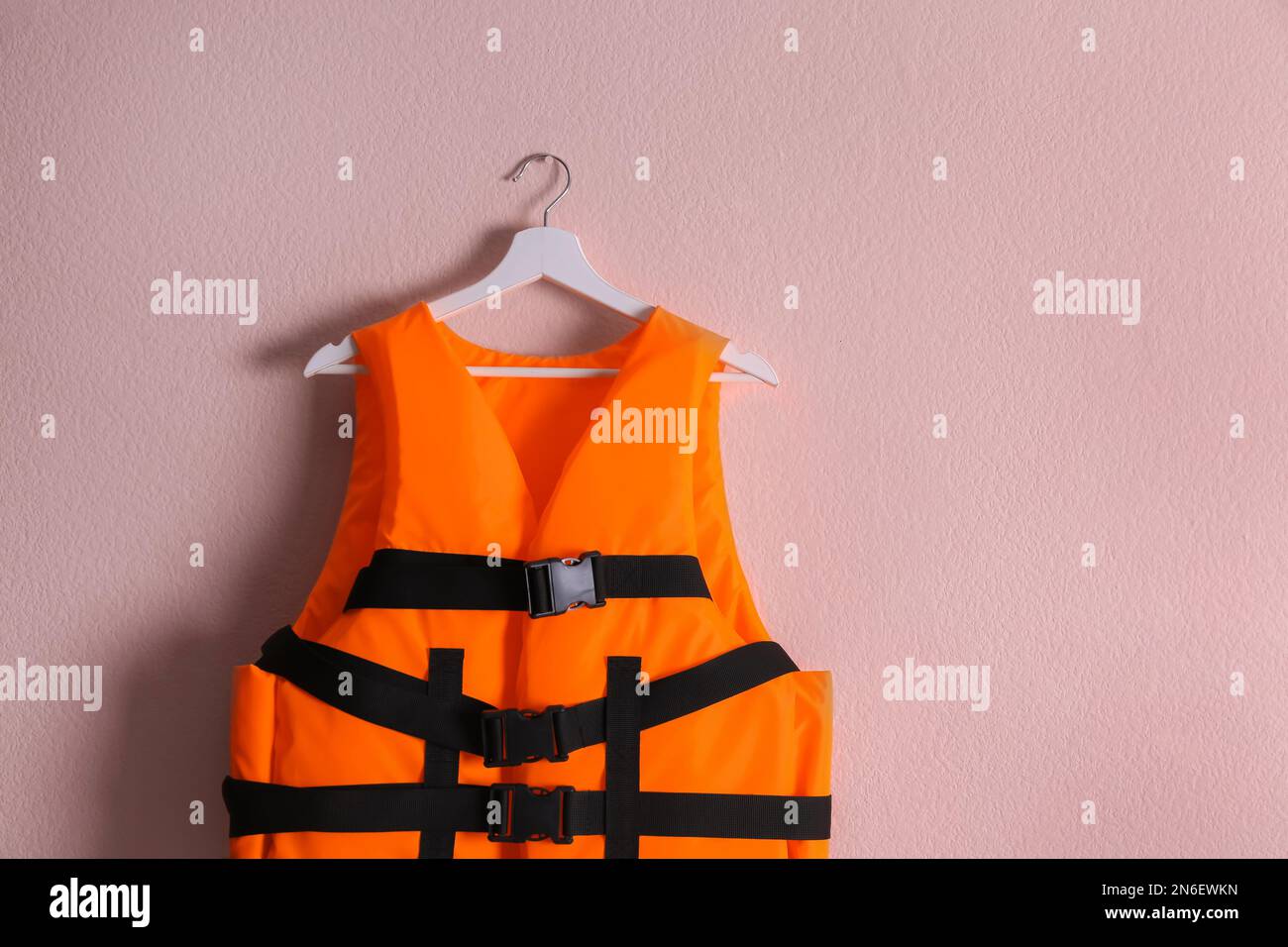 Orange life jacket on pink background. Personal flotation device Stock ...