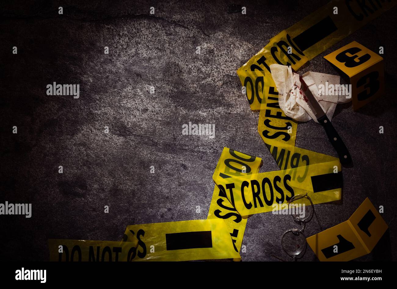 Flat lay composition with evidences and crime scene tape on grey stone ...