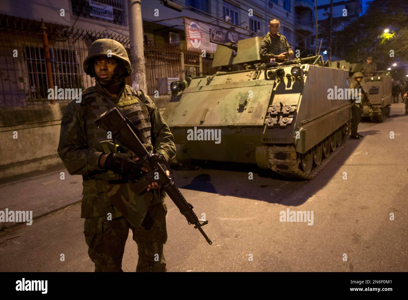 Brazilian soldiers patrol the Lins slum complex during an operation to ...