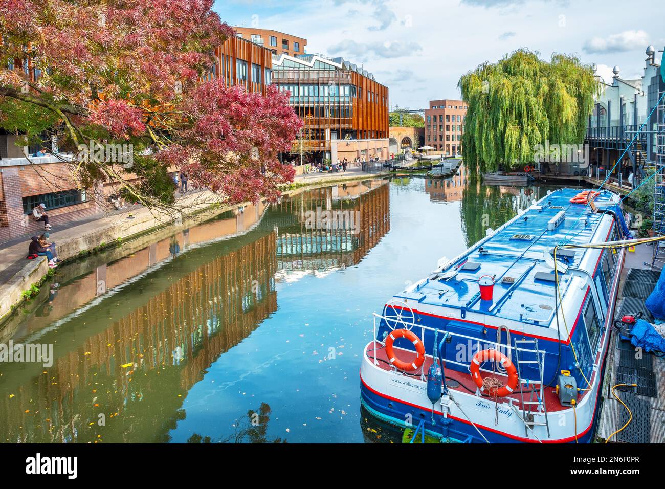 View to promenade along Regents Canal and tourist boat in Camden Town ...
