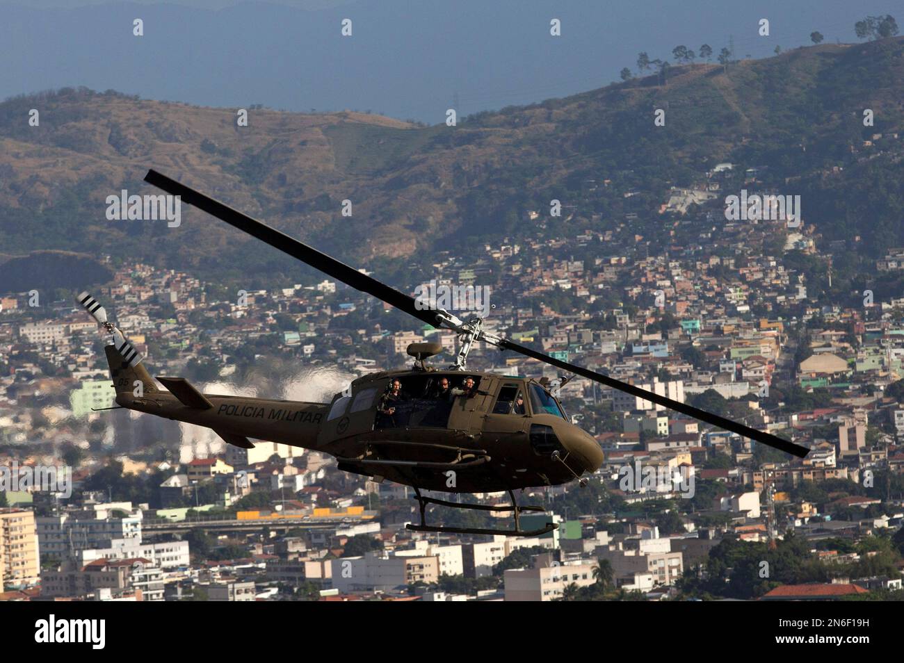 A military helicopter patrols the Lins slum complex during an operation ...