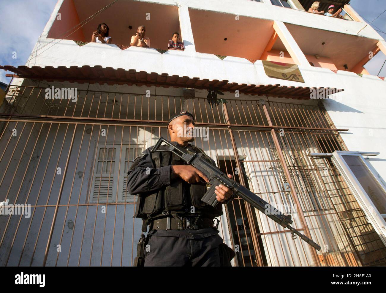 A police officer patrols the Lins slum complex during an operation to ...