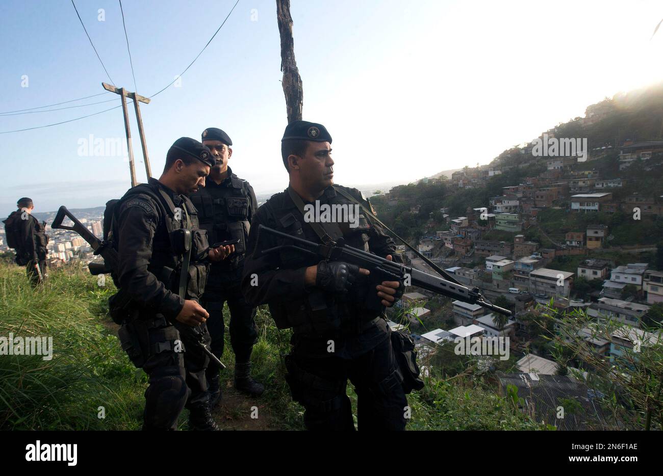 Police officers patrol the Lins slum complex during an operation to ...