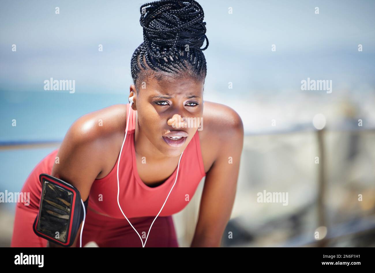 Tired, running and black woman with runner fatigue by the ocean for ...