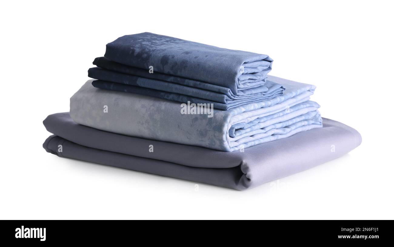 Stack of clean bed linen isolated on white Stock Photo - Alamy