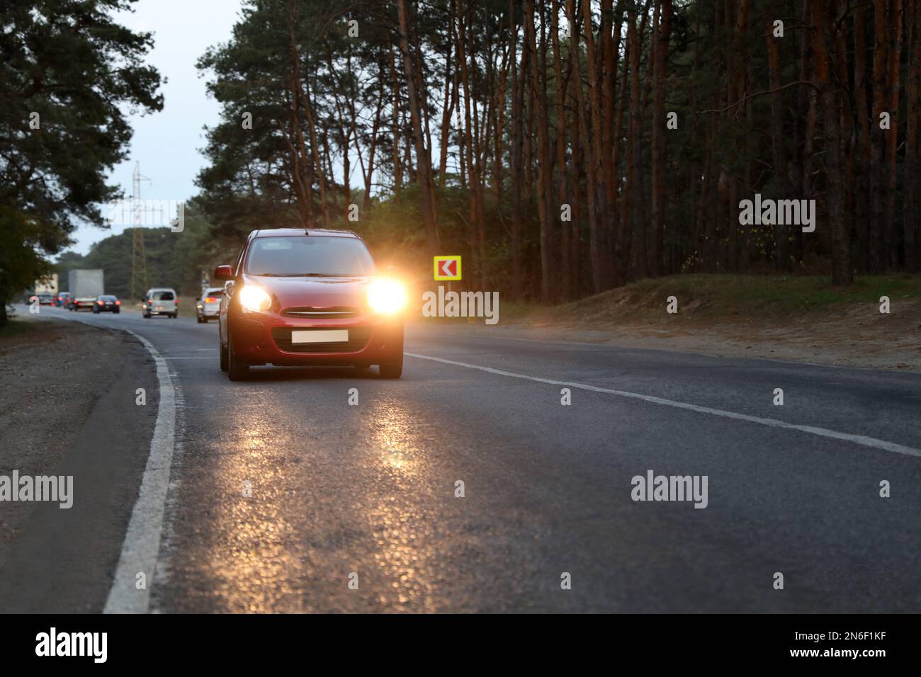 Red car on highway near wood. Road trip Stock Photo - Alamy