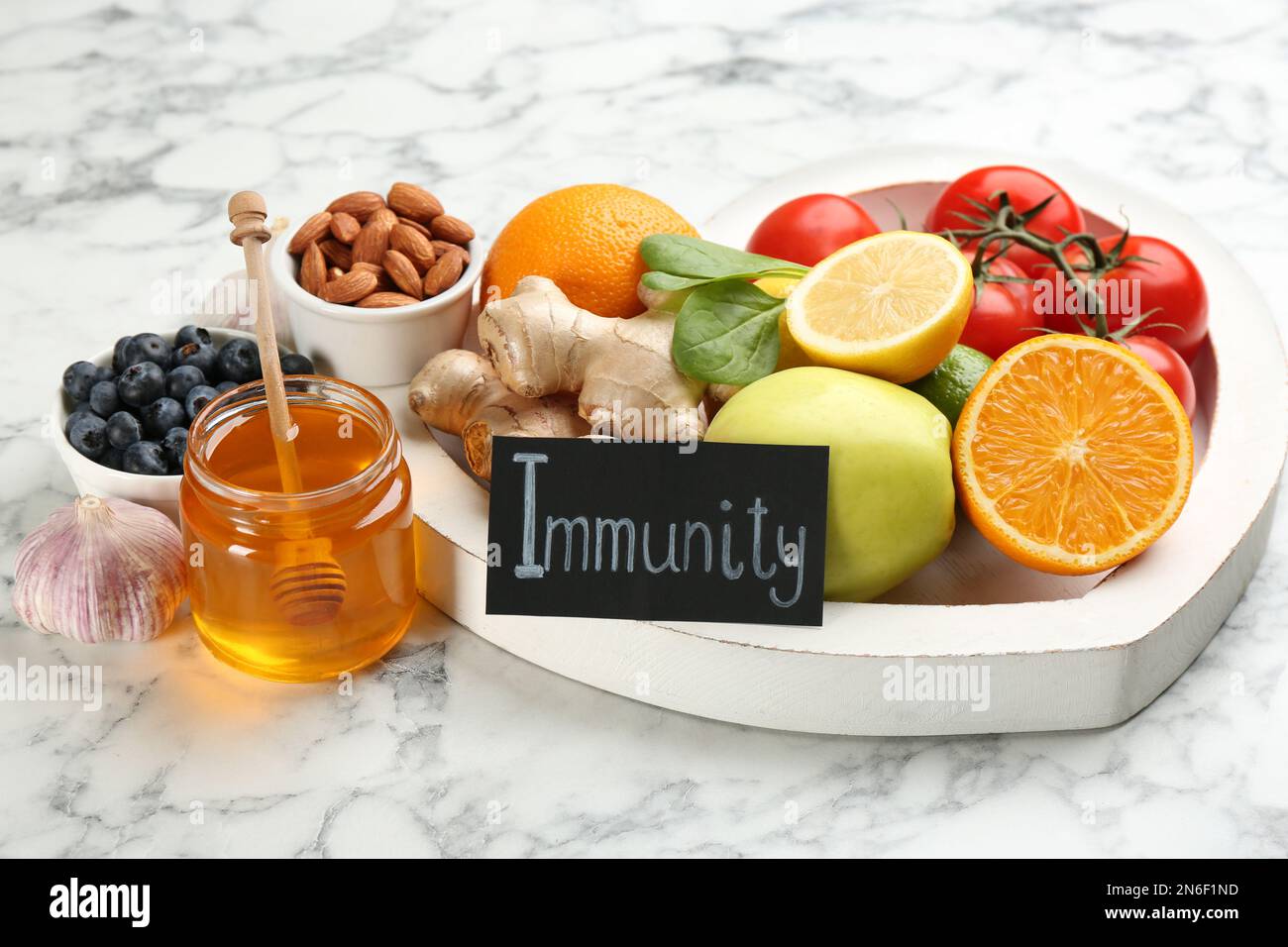 Card with word Immunity and fresh products on light marble background ...