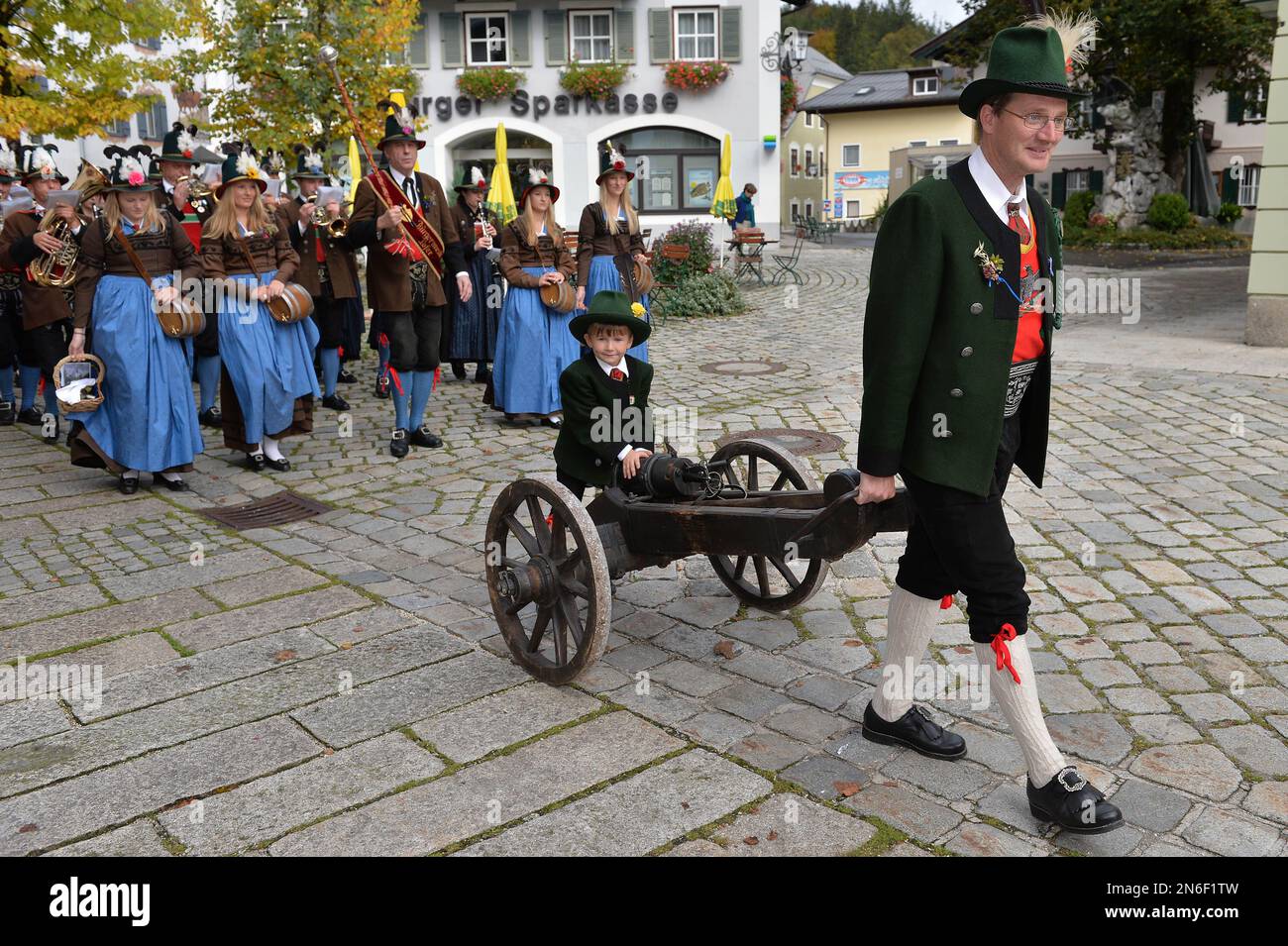Lorenz wearing a traditional costumes of a riflemen, sits on an old ...