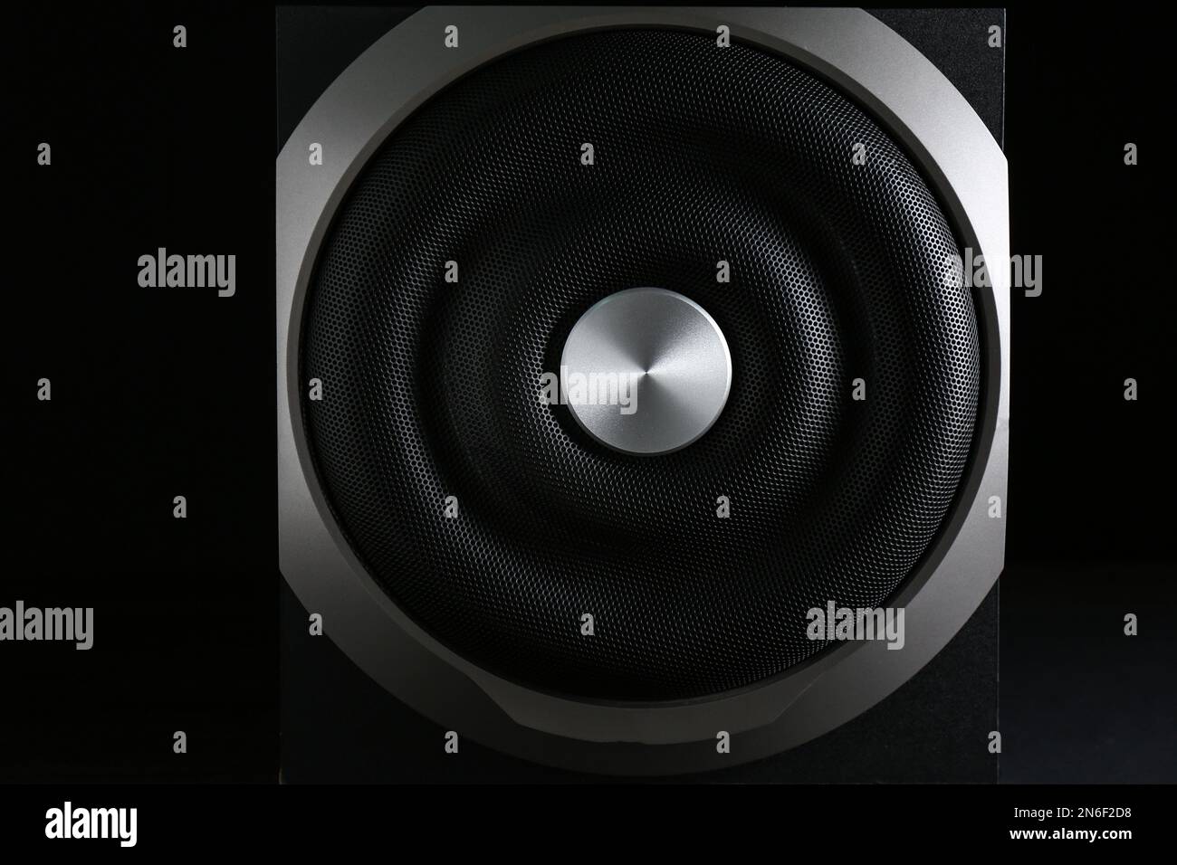 Modern subwoofer on black background, closeup. Powerful audio speaker ...