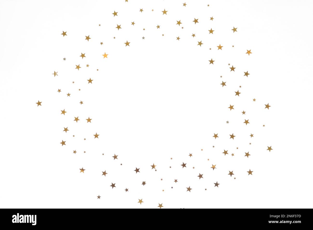 Frame made of star shaped confetti on white background, top view. Space ...