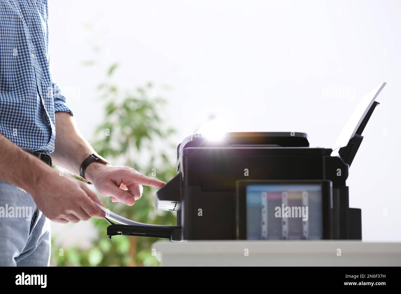 Employee using modern printer in office, closeup Stock Photo - Alamy