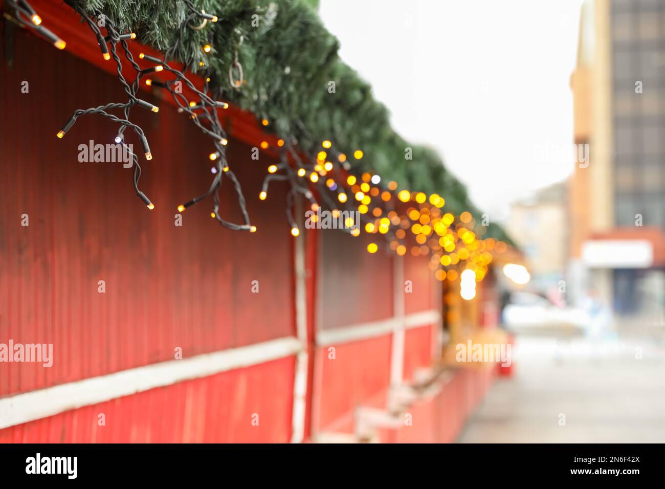 Christmas fair stall with string lights outdoors Stock Photo - Alamy