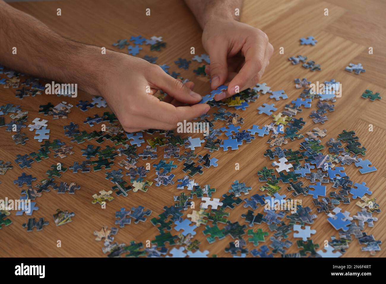 Hands build wooden puzzles hi-res stock photography and images - Alamy