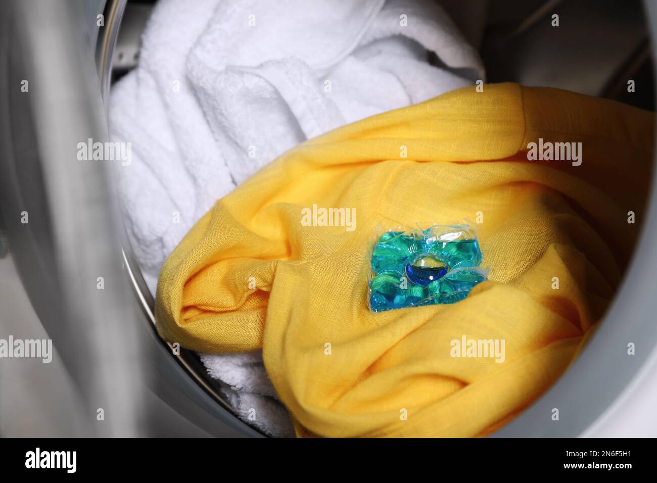 Laundry detergent capsule in washing machine drum, closeup view Stock ...