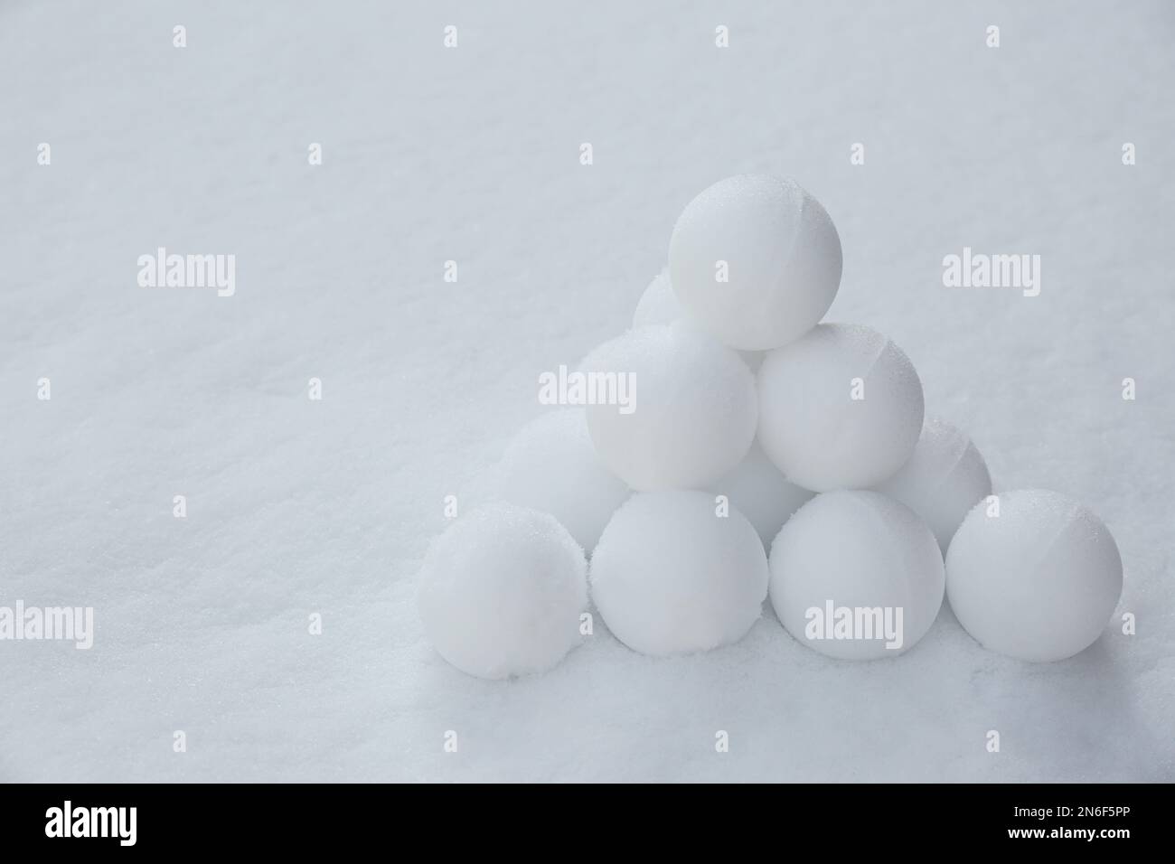 Pyramid of perfect snowballs on snow outdoors. Space for text Stock ...
