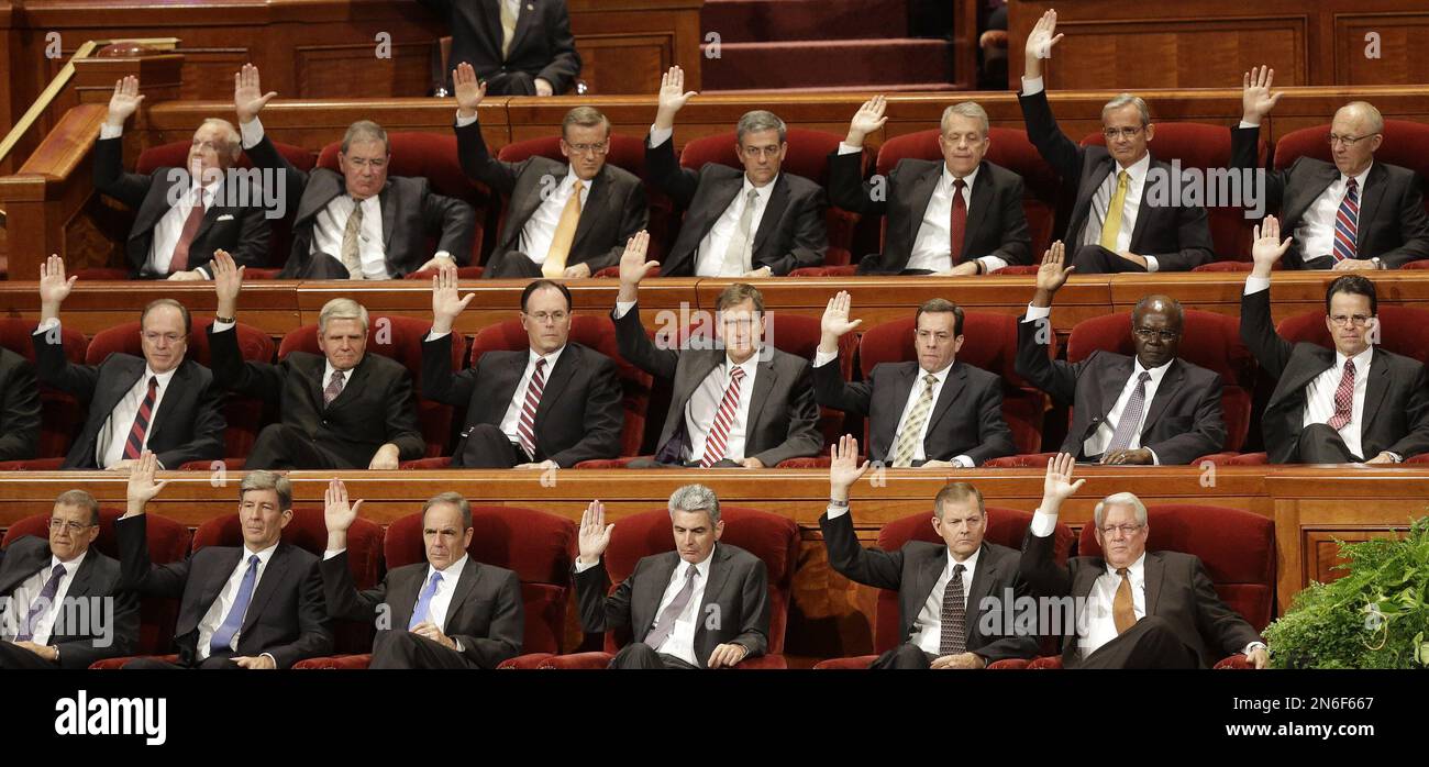 Members of the Seventy raise their hands during a sustaining vote at ...