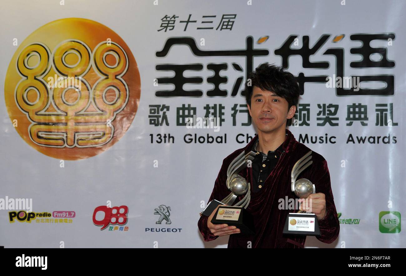 Malaysian singer Michael Wong poses with his trophies during the 13th ...