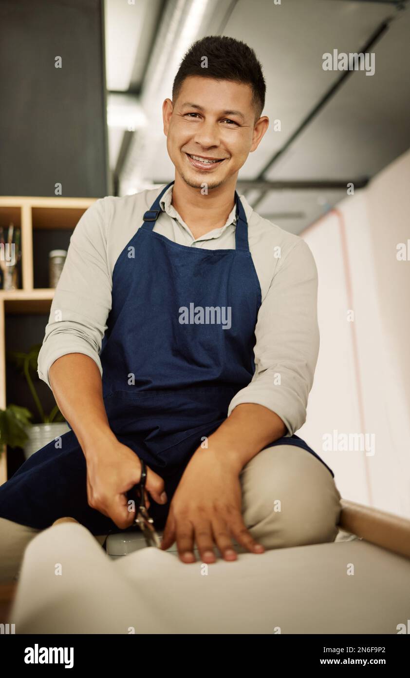 Portrait of designer cutting fabric. Young tailor cutting material with ...