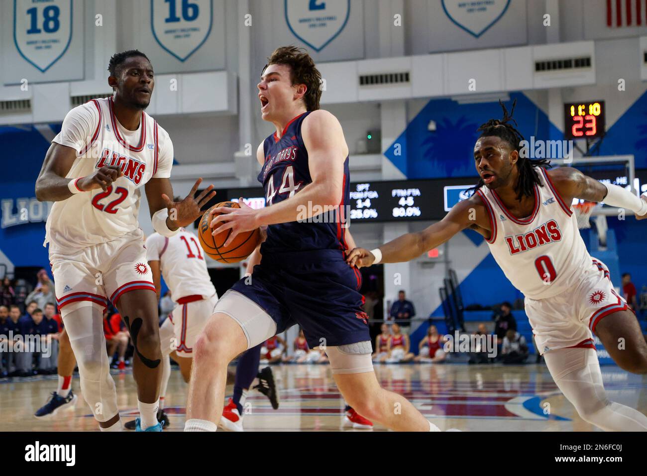 Saint Mary's guard Alex Ducas (44) drives between Loyola Marymount ...