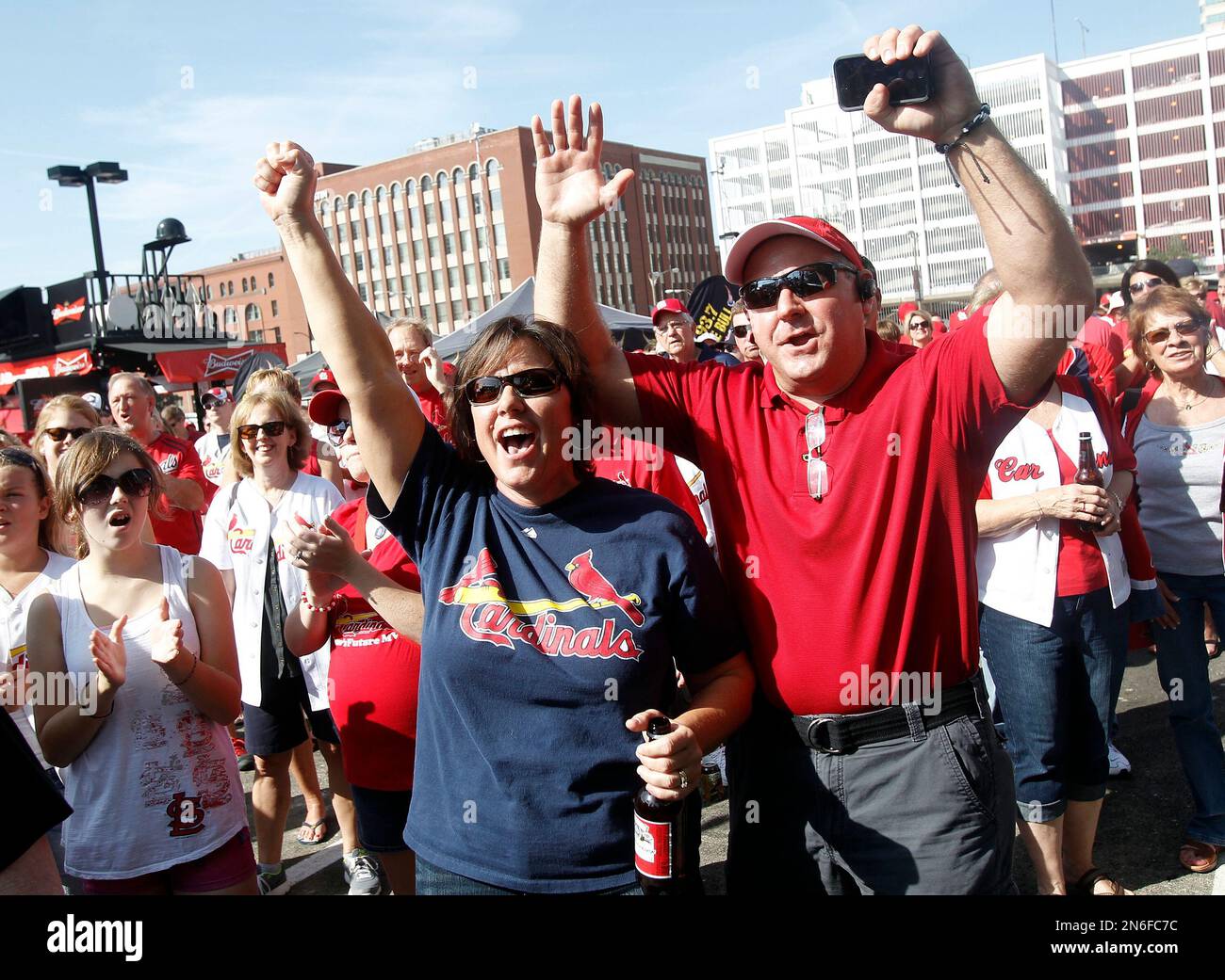 St. Louis Cardinals fans Terri, left, and Matt Lanham cheer at a pep ...