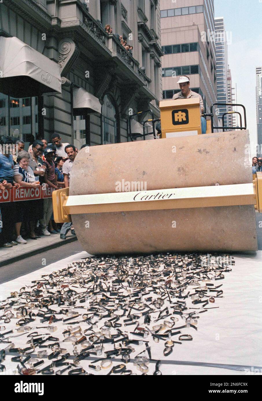 Counterfeit Cartier watches are crushed by a steamroller next to ...