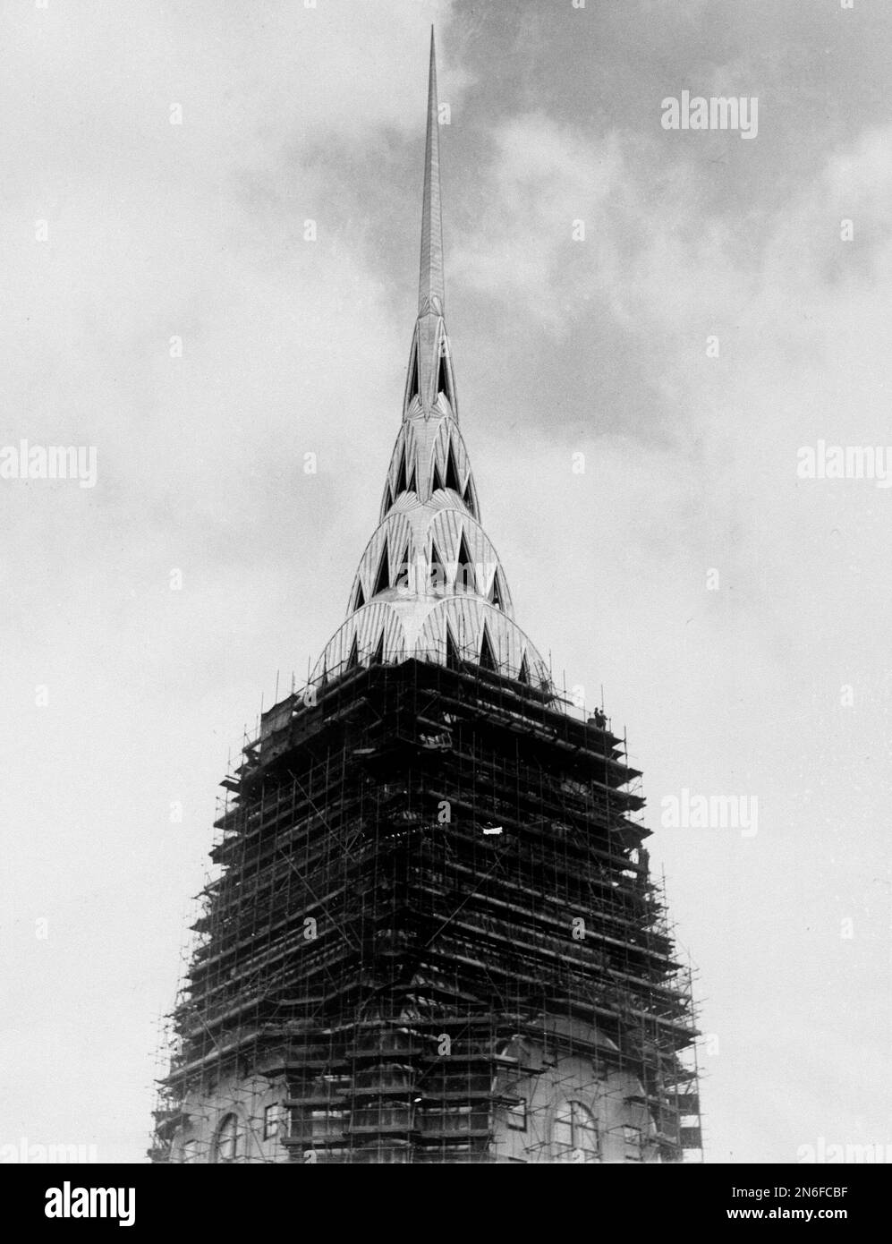 The sharp, glistening spire of the Chrysler Building stands revealed as ...