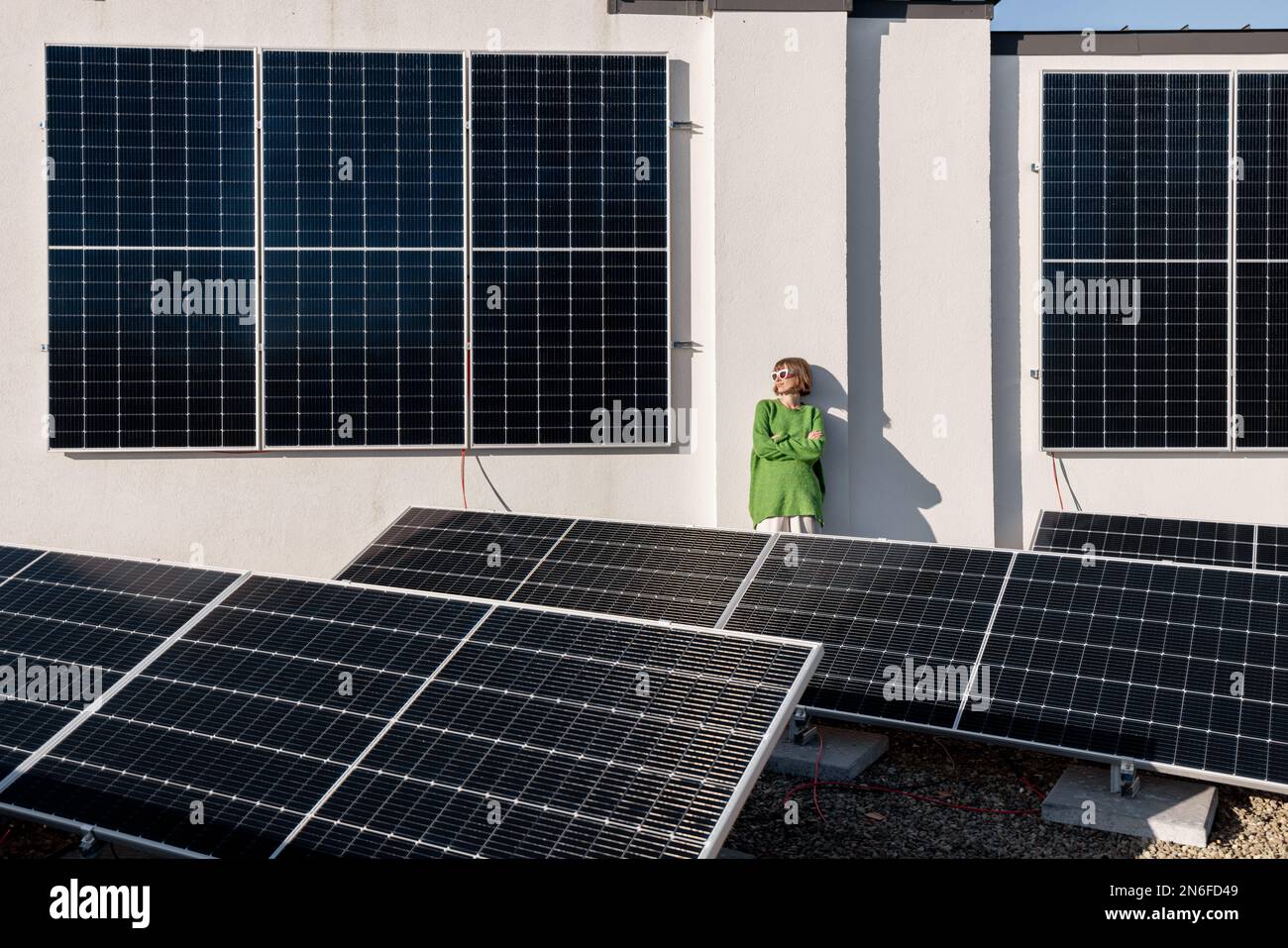 Solar power plant installed on rooftop with a woman owner Stock Photo ...