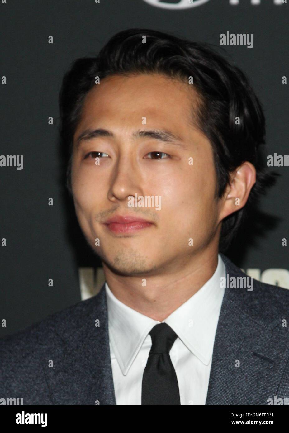 Actor Steven Yeun arrives at the season 4 premiere of "The Walking Dead ...