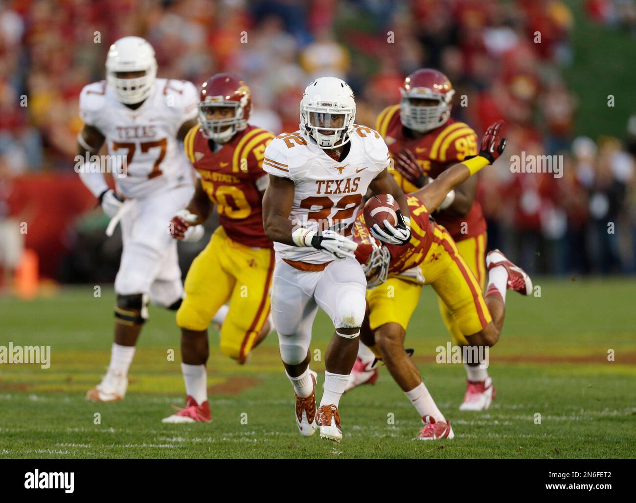 Texas running back Johnathan Gray (32) runs from Iowa State defenders ...