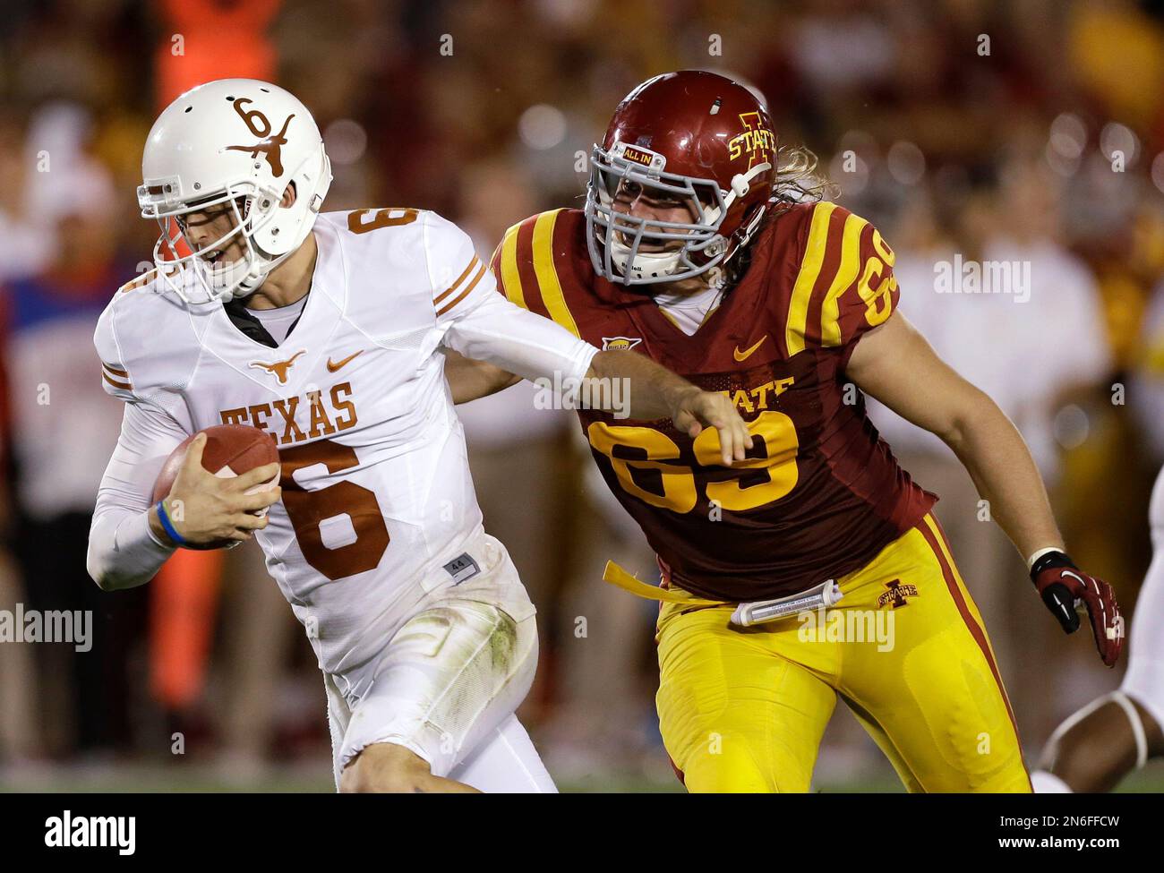 Texas quarterback Case McCoy runs from Iowa State's Nick Kron, right ...