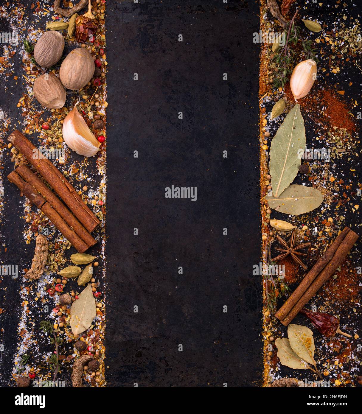 Different spices and herbs on a black background Stock Photo - Alamy