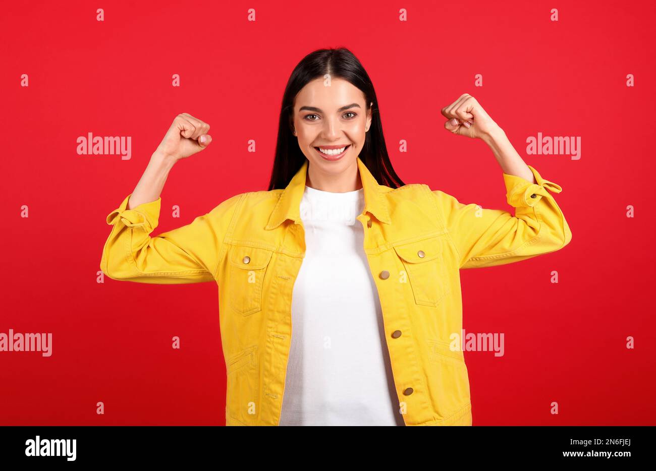 Strong woman as symbol of girl power on red background. 8 March concept ...