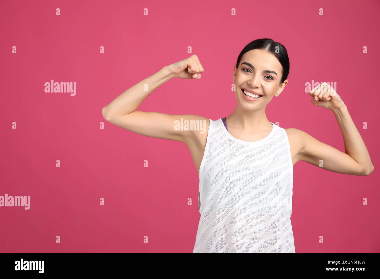 Strong woman as symbol of girl power on pink background. 8 March ...