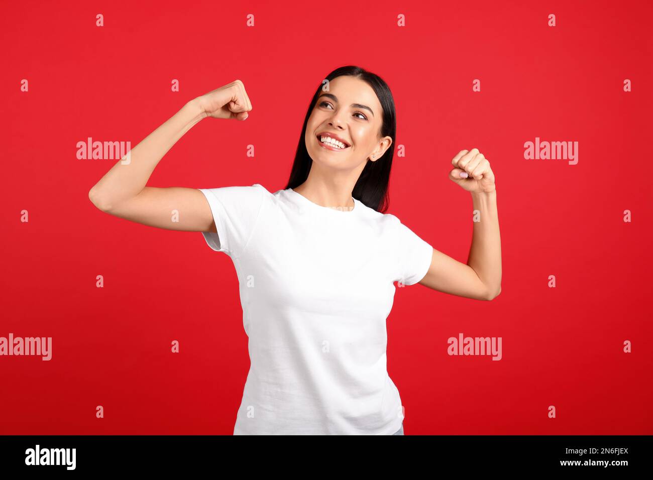 Strong woman as symbol of girl power on red background. 8 March concept ...