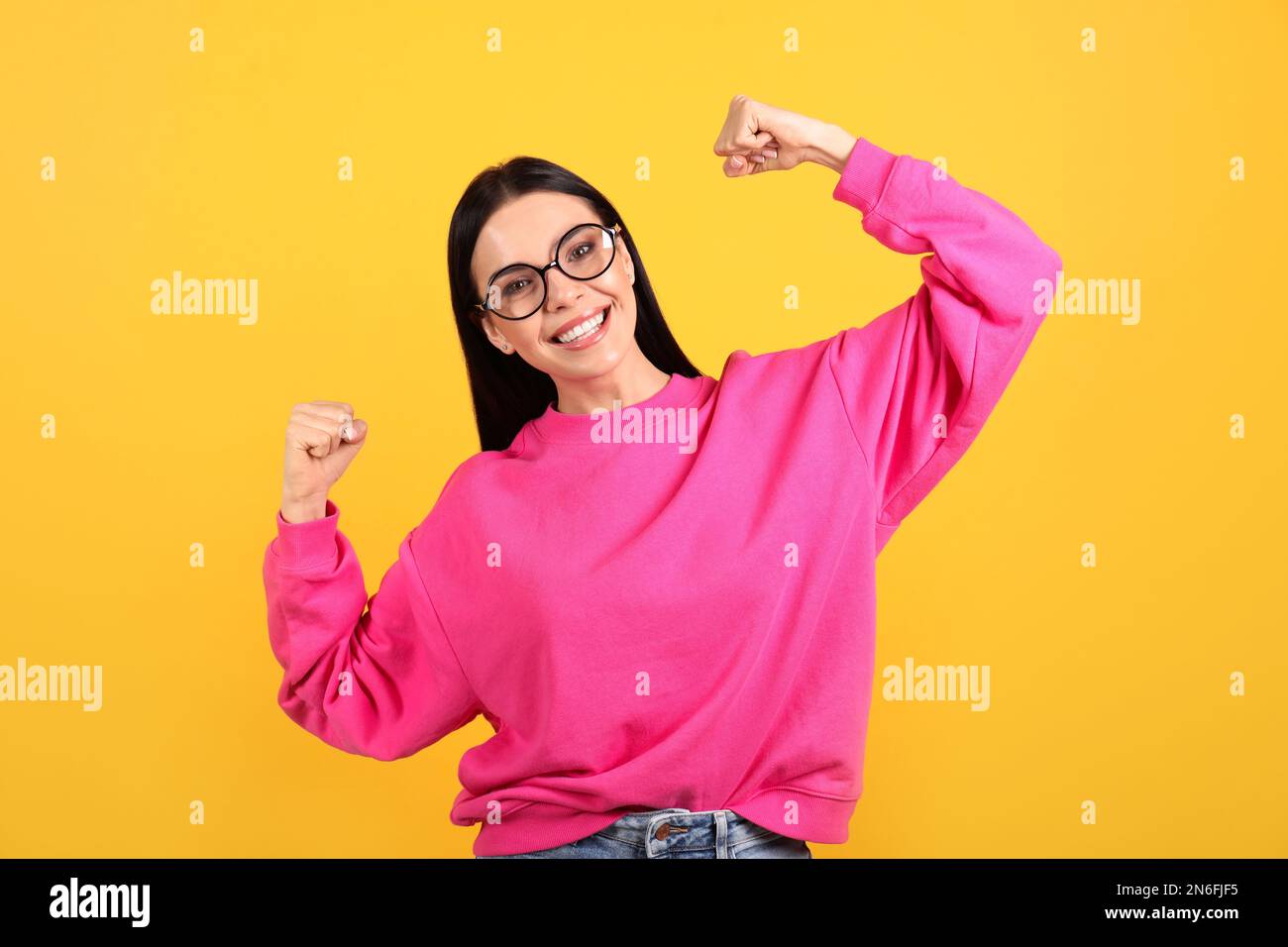Strong woman as symbol of girl power on yellow background. 8 March ...