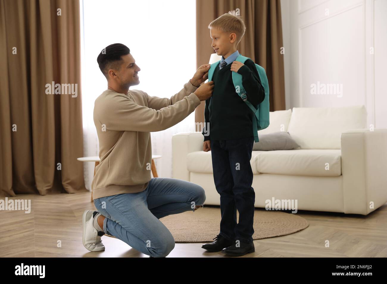 Father helping his little child get ready for school at home Stock ...