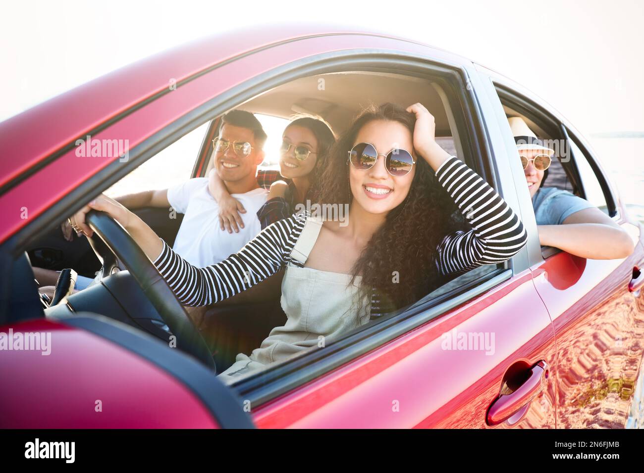 Happy friends together in car on road trip Stock Photo - Alamy