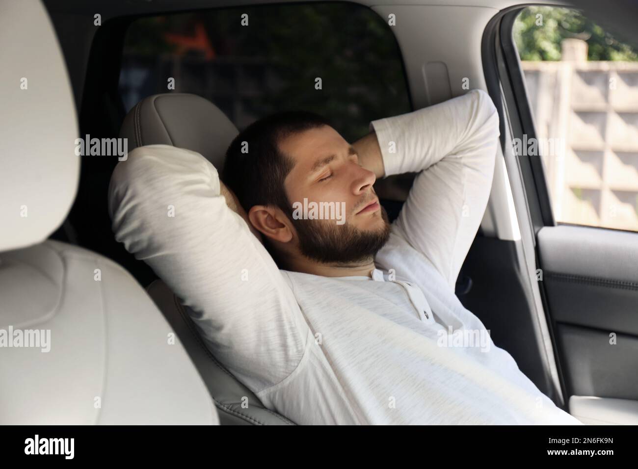 Tired man sleeping in his modern car Stock Photo - Alamy