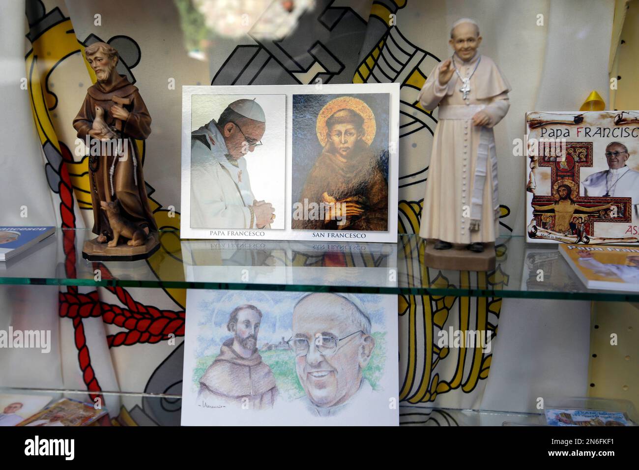 Postcards and statuettes of Pope Francis and St. Francis are shown on a ...