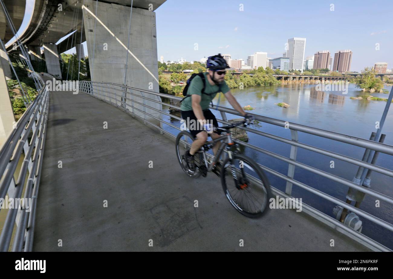 This Oct. 1, 2013 photo shows a bicyclist riding on a bridge suspended ...